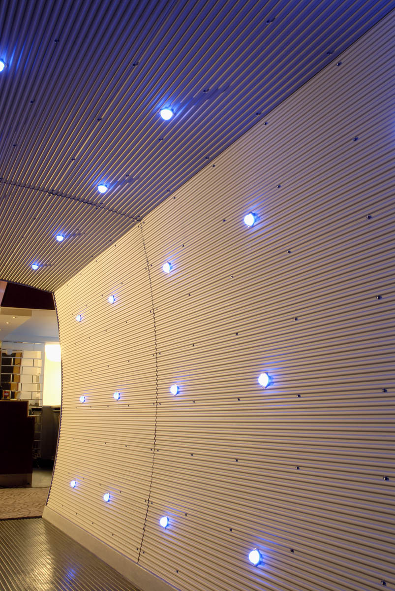 Bespoke interior wall cladding in corrugated aluminium sheet